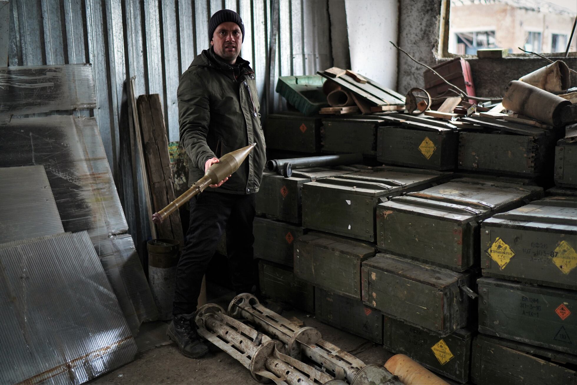 Sergei Yatsenko displays ammunition left by the Russians after their ...